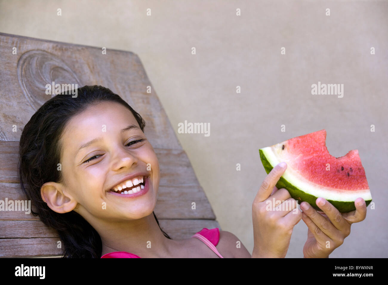 Smiling girl eating watermelon Stock Photo - Alamy