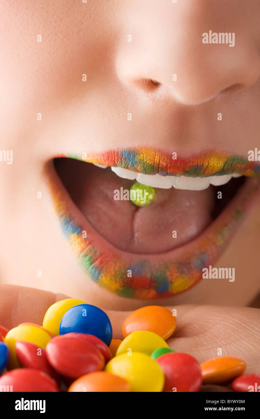 close up of a mouth with multicolor lips and colored smarties Stock ...