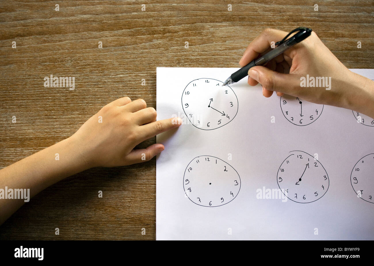 Young girl learning to read the time Stock Photo - Alamy