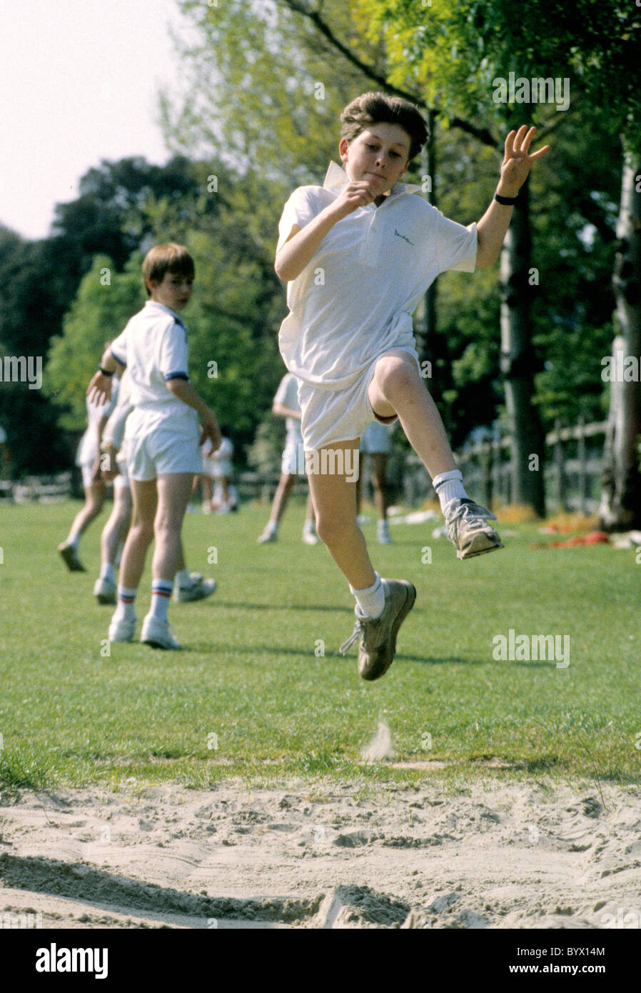 A boy jumping during school sports day Stock Photo - Alamy