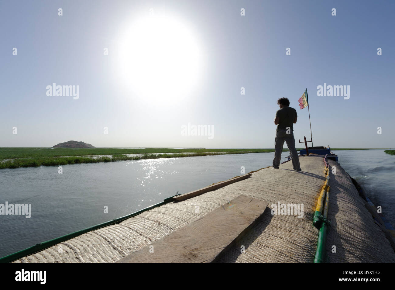 Western tourist standing on the roof of a pinasse during a boattrip on ...