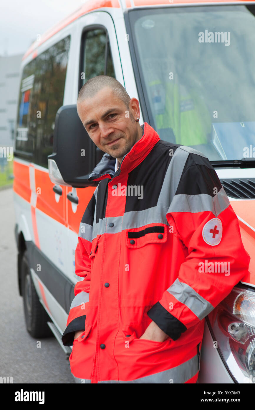 Ambulance man in front of coach, happy Stock Photo - Alamy