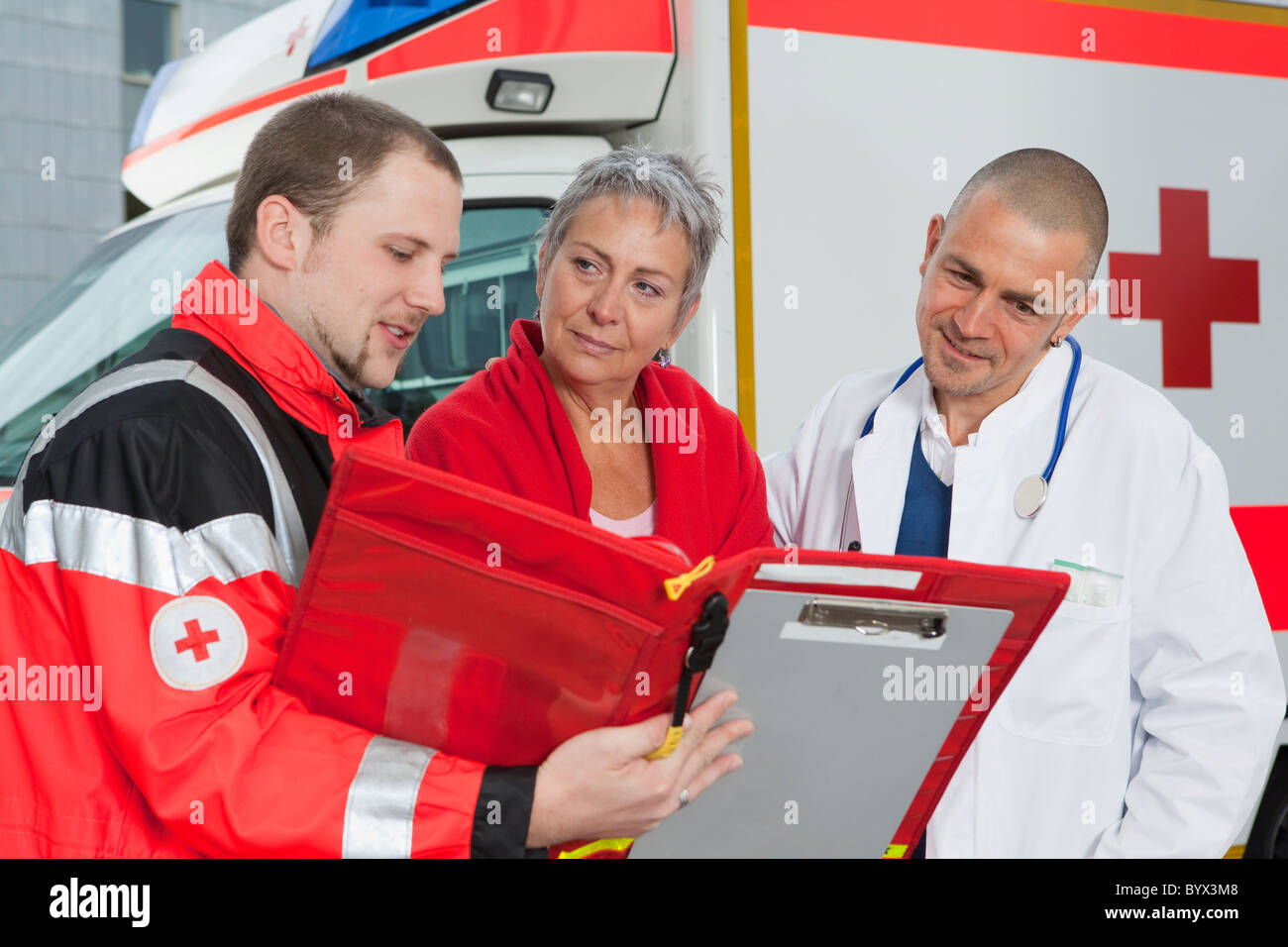 Examining patient doctor reviewing medical hi-res stock photography and ...