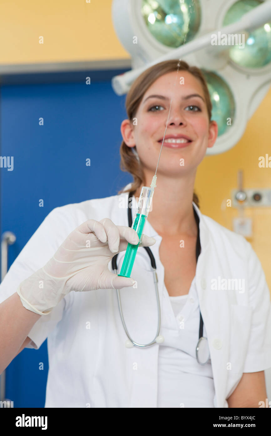 Nurse preparing injection, happy Stock Photo - Alamy