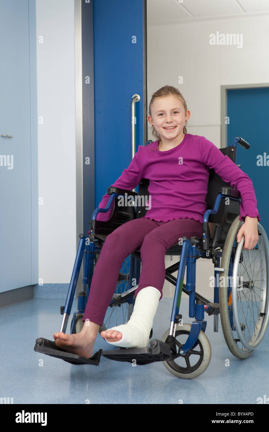 Girl in wheelchair, foot in plaster Stock Photo - Alamy