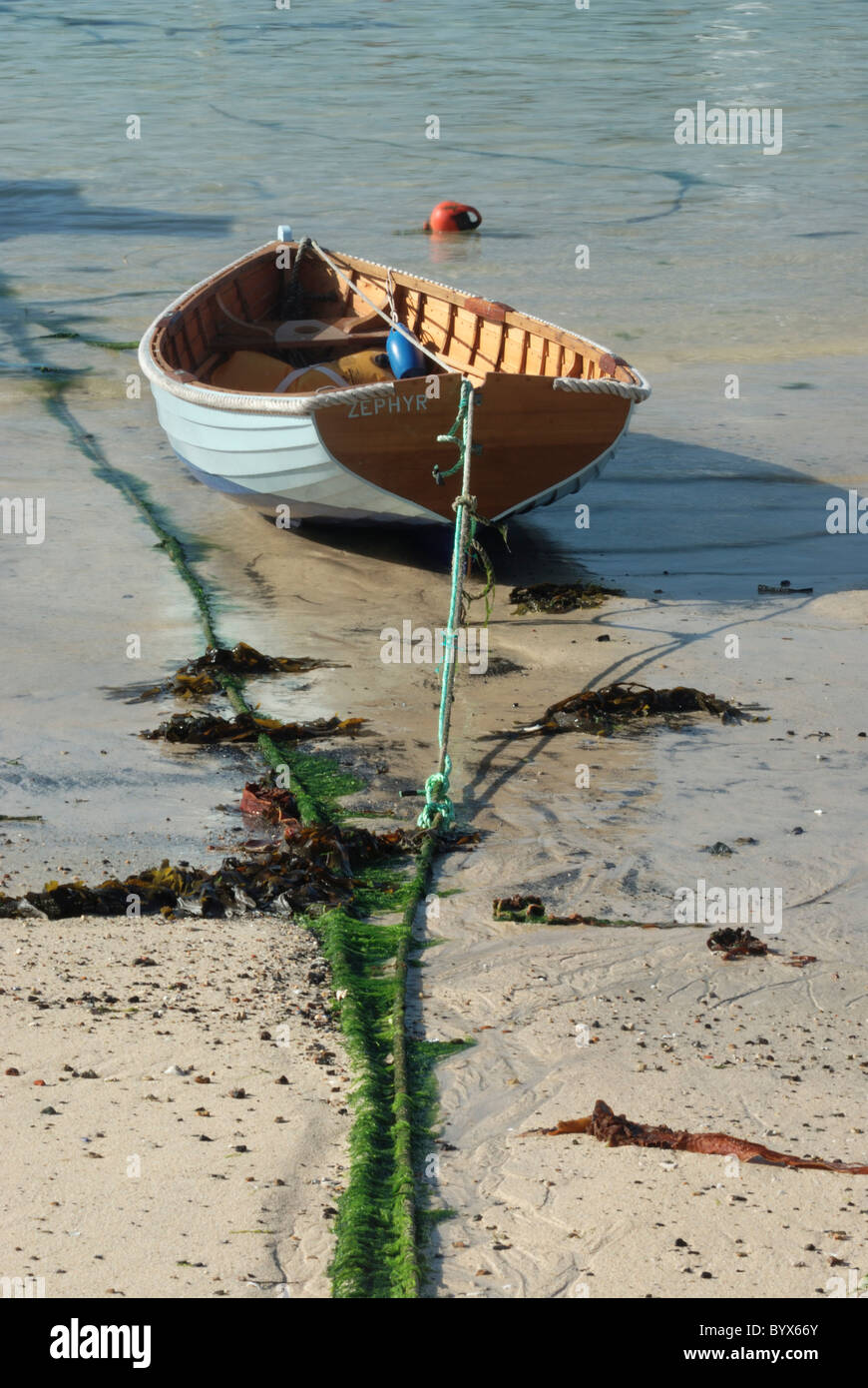 tethered small fishing/recreational boat in the harbour at St Ives ...