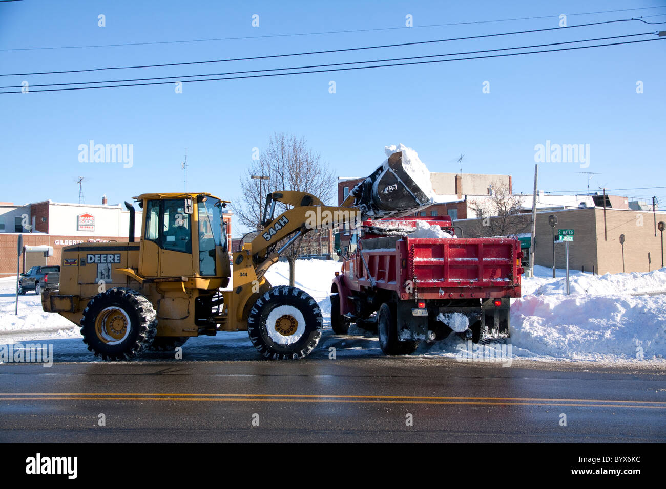 Front Loader and Dump Truck clearing snow from street after recent ...