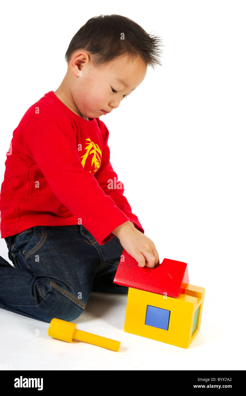 Little Chinese boys playing with woodenhouse and blocs Stock Photo - Alamy