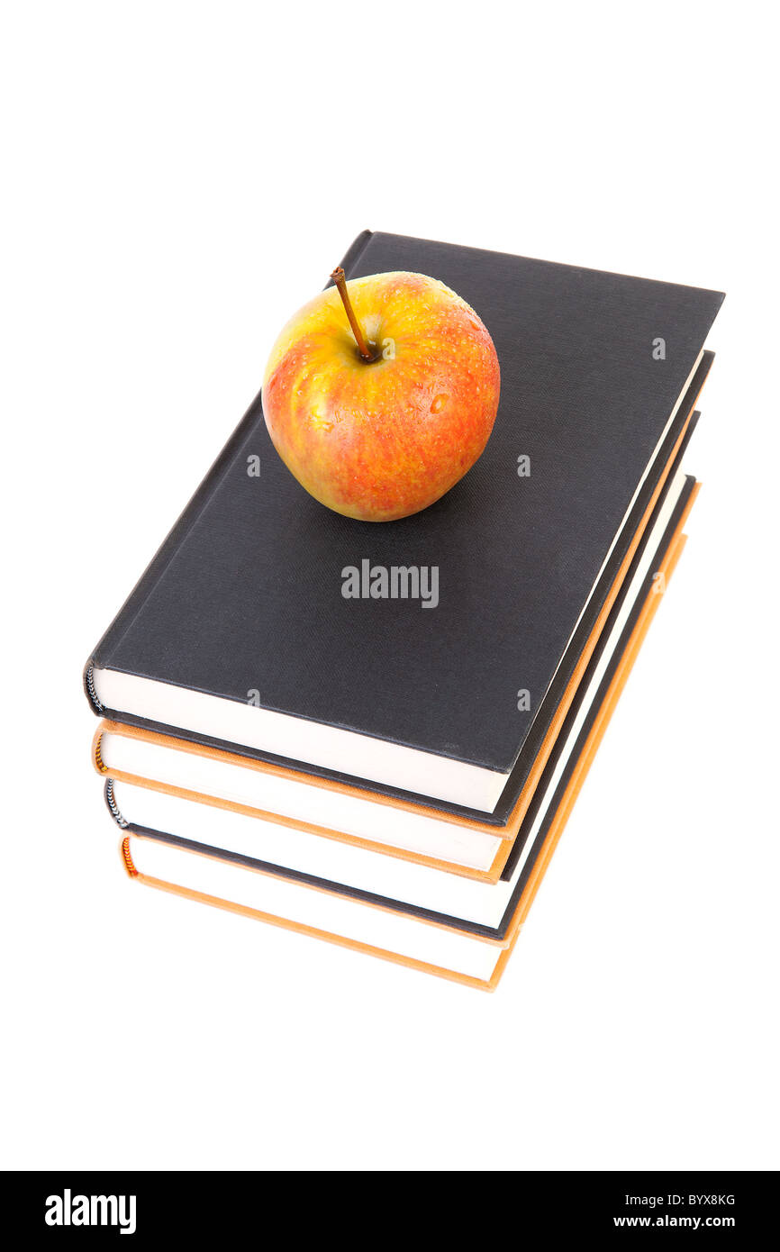 back to school: stack of books with apple on top over white background ...