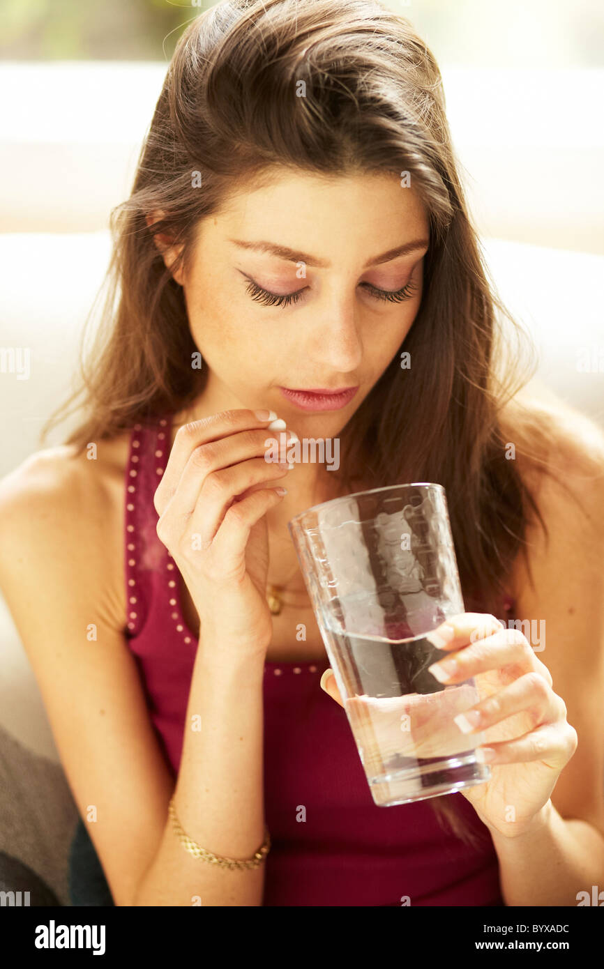 Girl taking tablet Stock Photo - Alamy