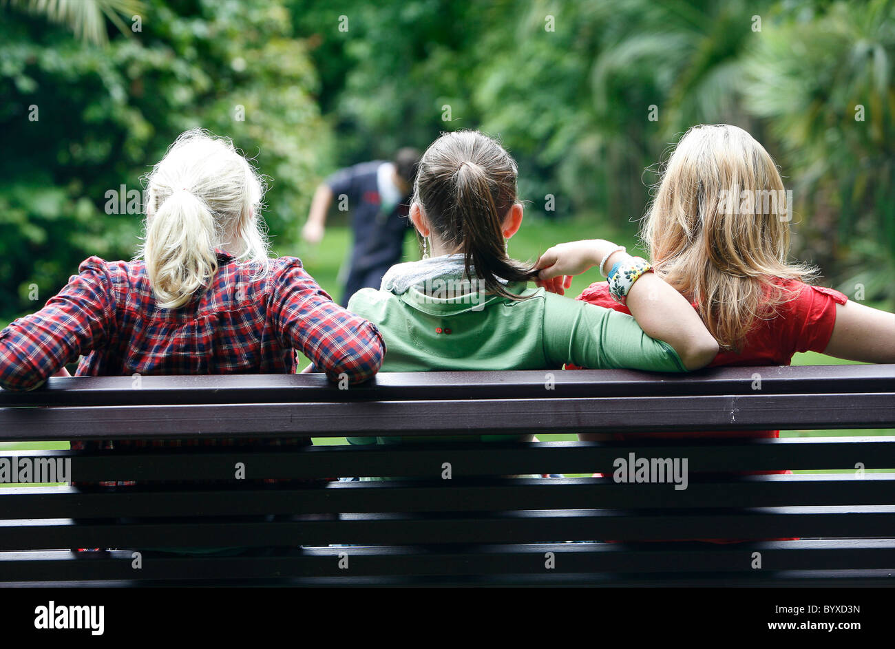 Teenage girls sitting on a bench Stock Photo - Alamy