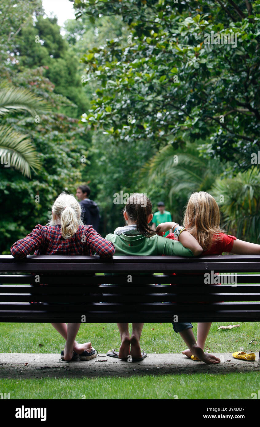 Teenage girls sitting on a bench Stock Photo - Alamy