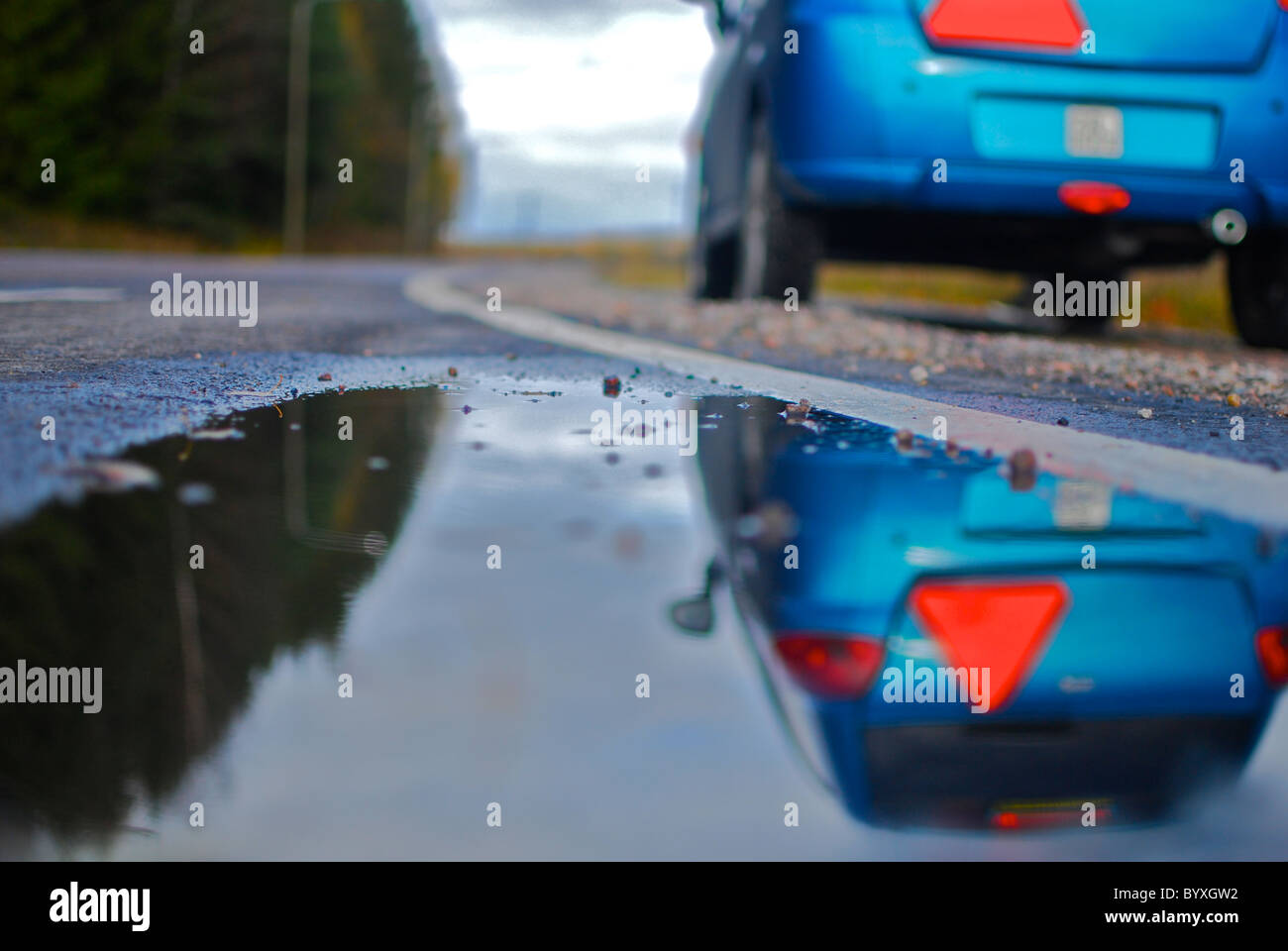 Reflection of a car in a puddle Stock Photo - Alamy