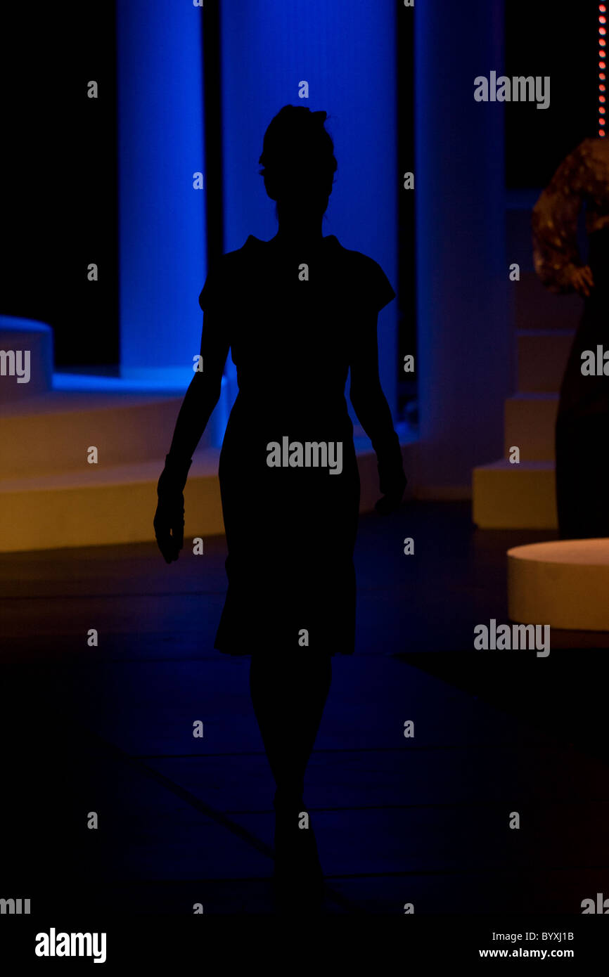 silhouette female figure walking blue background Stock Photo - Alamy