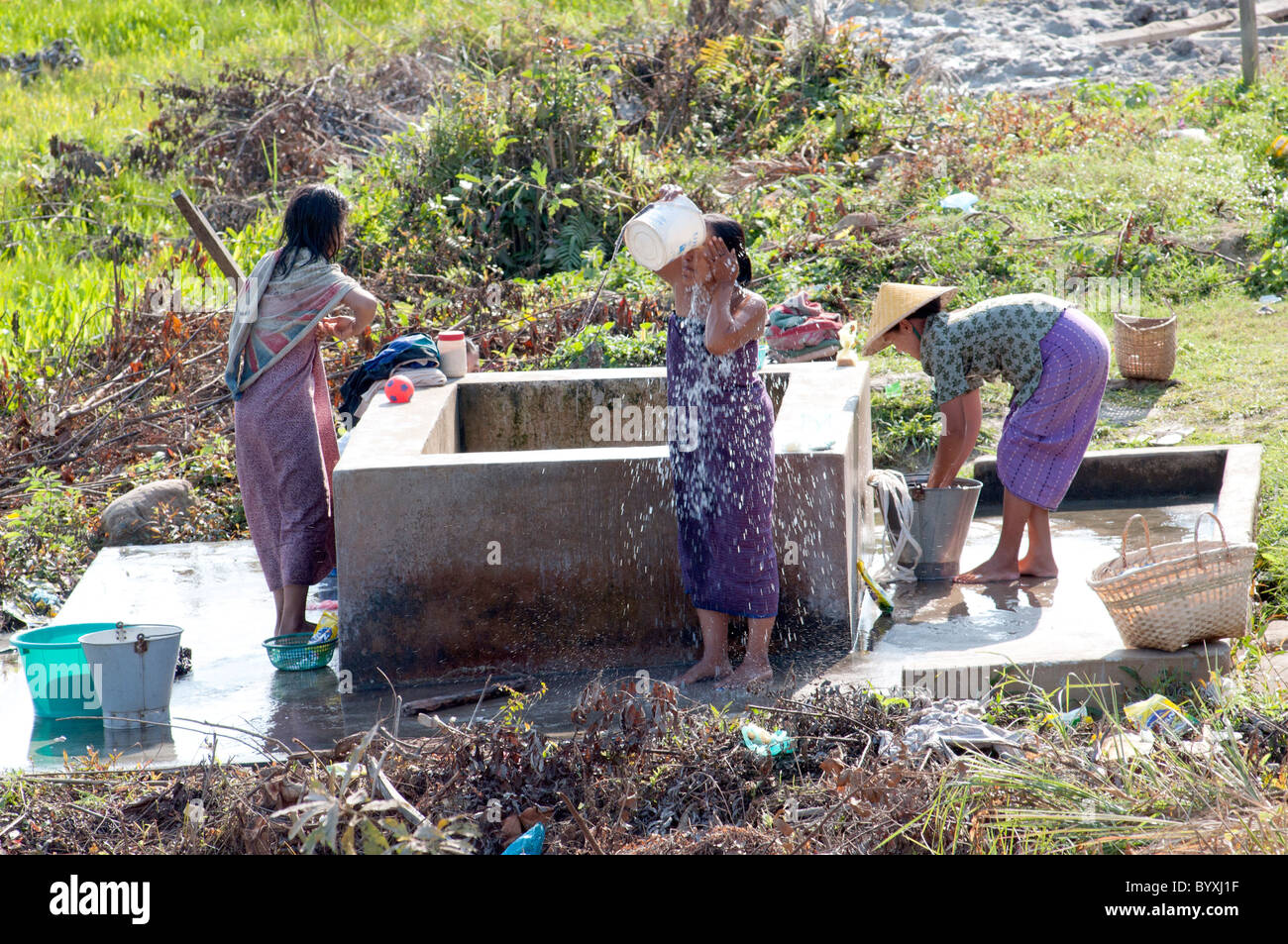 MYANMAR/BURMA. WASHING CLOTHES ON THE IRRAWADY RIVER IN KATHA WHERE ...