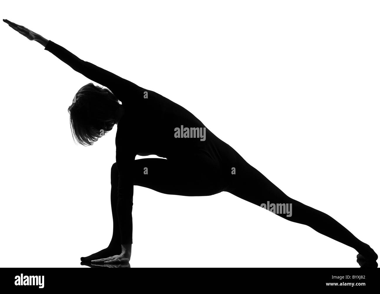 woman yoga posture Extended Side Angle Pose position in silouhette on ...