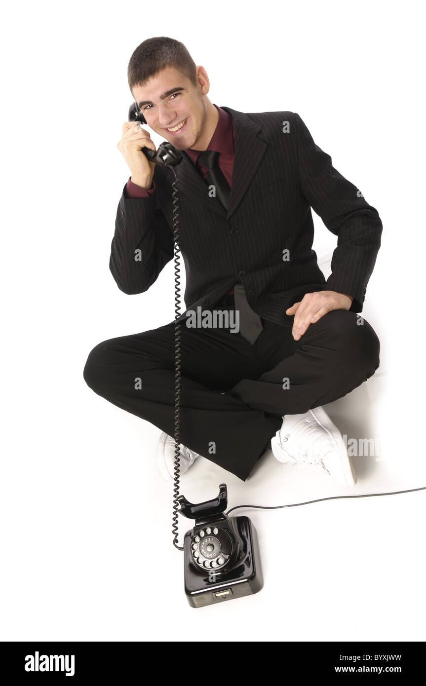 Young man in suit with antique phone calls Stock Photo - Alamy