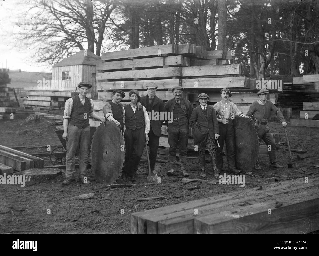 Sawmill workers posing with wood cutting blades in the Scottish Borders ...