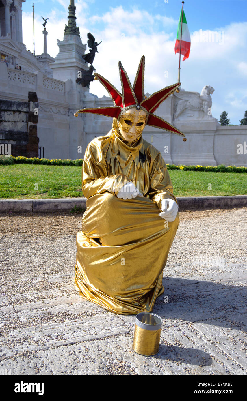 Busker wearing a golden jester costume, Rome Stock Photo - Alamy