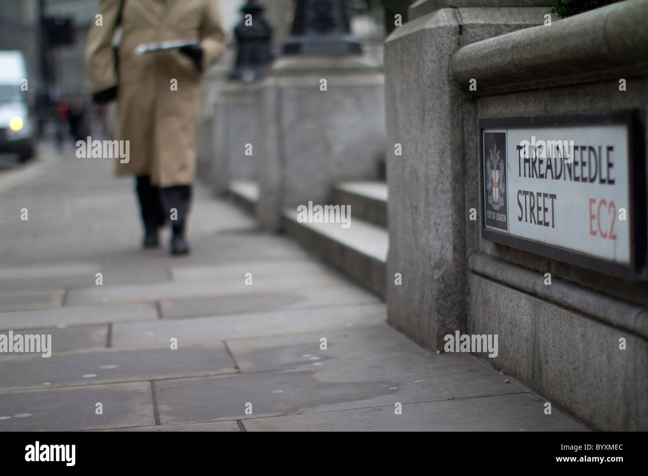 Threadneedle street road sign, with city commuter worker near bank of ...