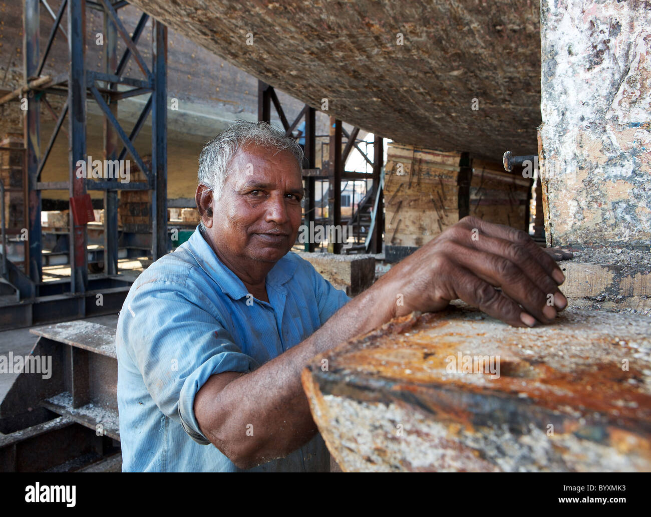 Dockyard worker repairing a dhow in the Jaddaf dockyard, Dubai, UAE ...