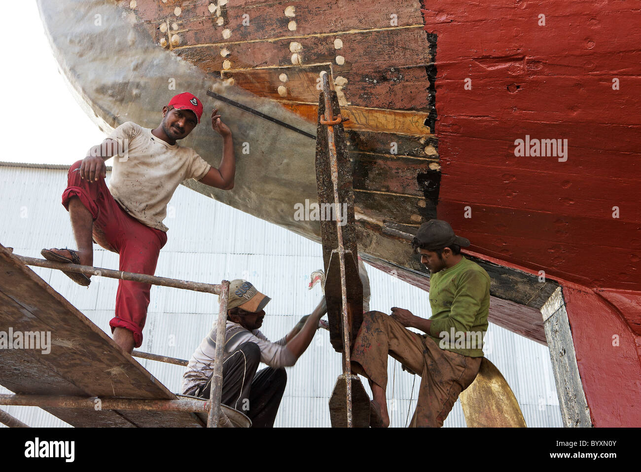 Arab dockyard workers repair a dhow in Jaddaf dockyard, Dubai, UAE ...