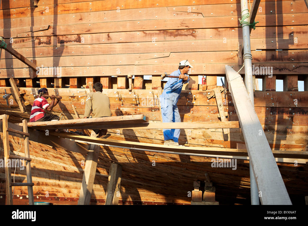 An enormous new traditional wooden dhow under construction, Jaddaf ...