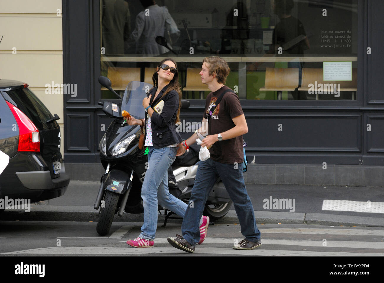 French couple walking together on the street in the city of Paris ...