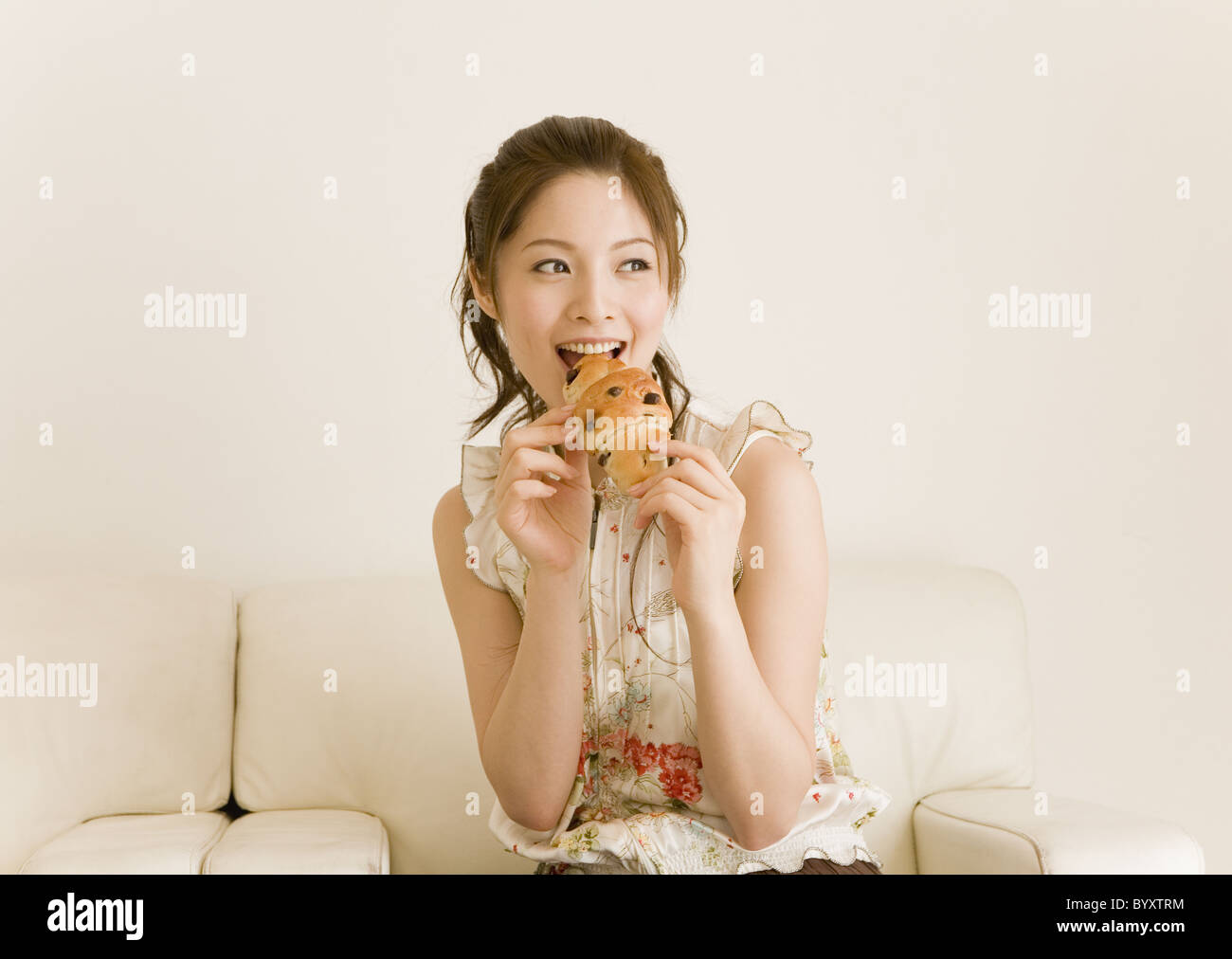 Woman eating bread Stock Photo - Alamy