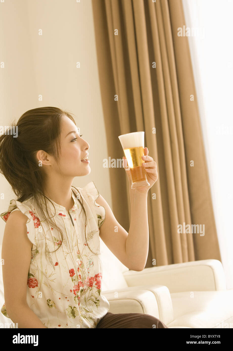 Woman drinking beer Stock Photo - Alamy