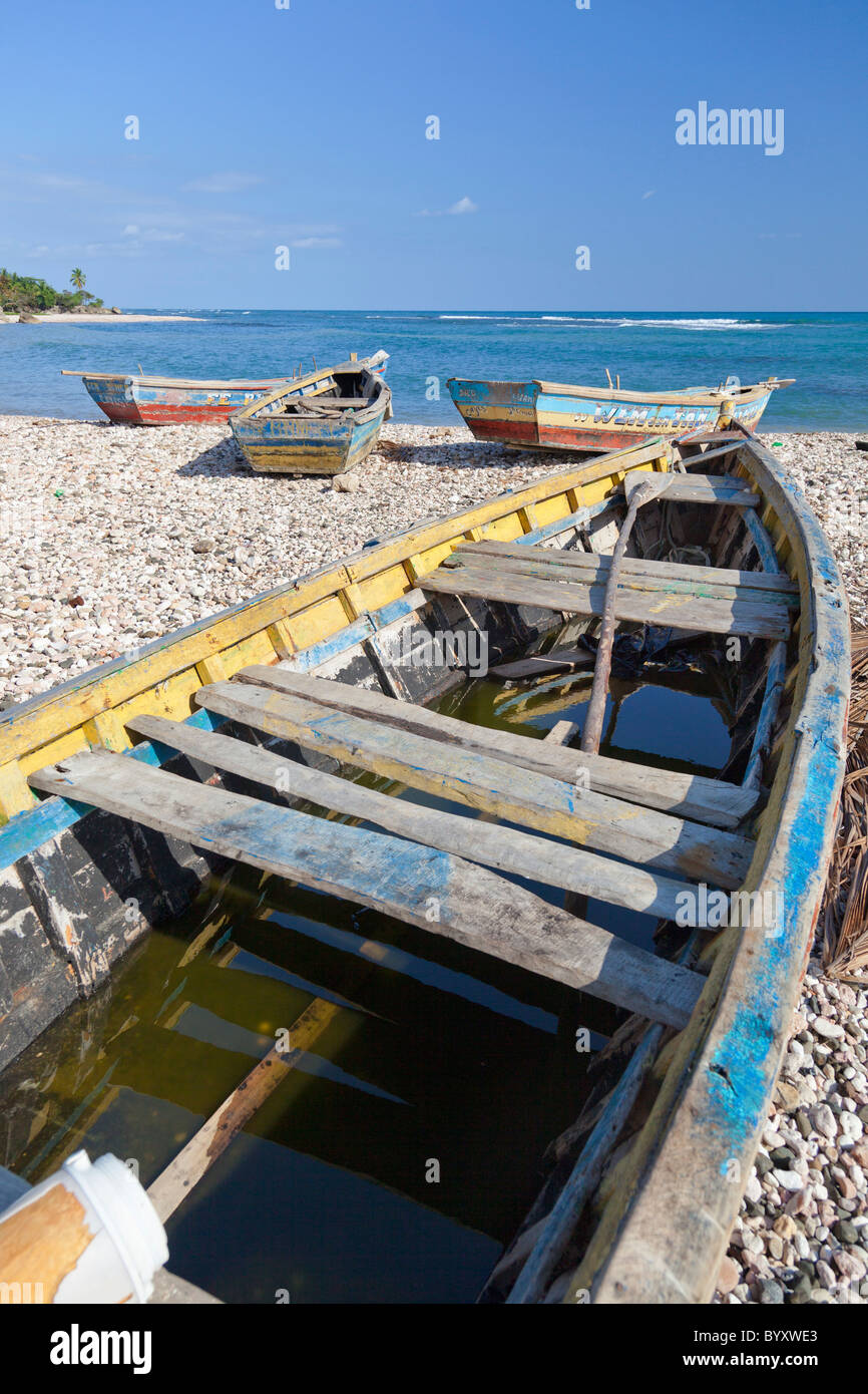 wooden row boats on the rocky shore; jacmel, haiti Stock Photo - Alamy