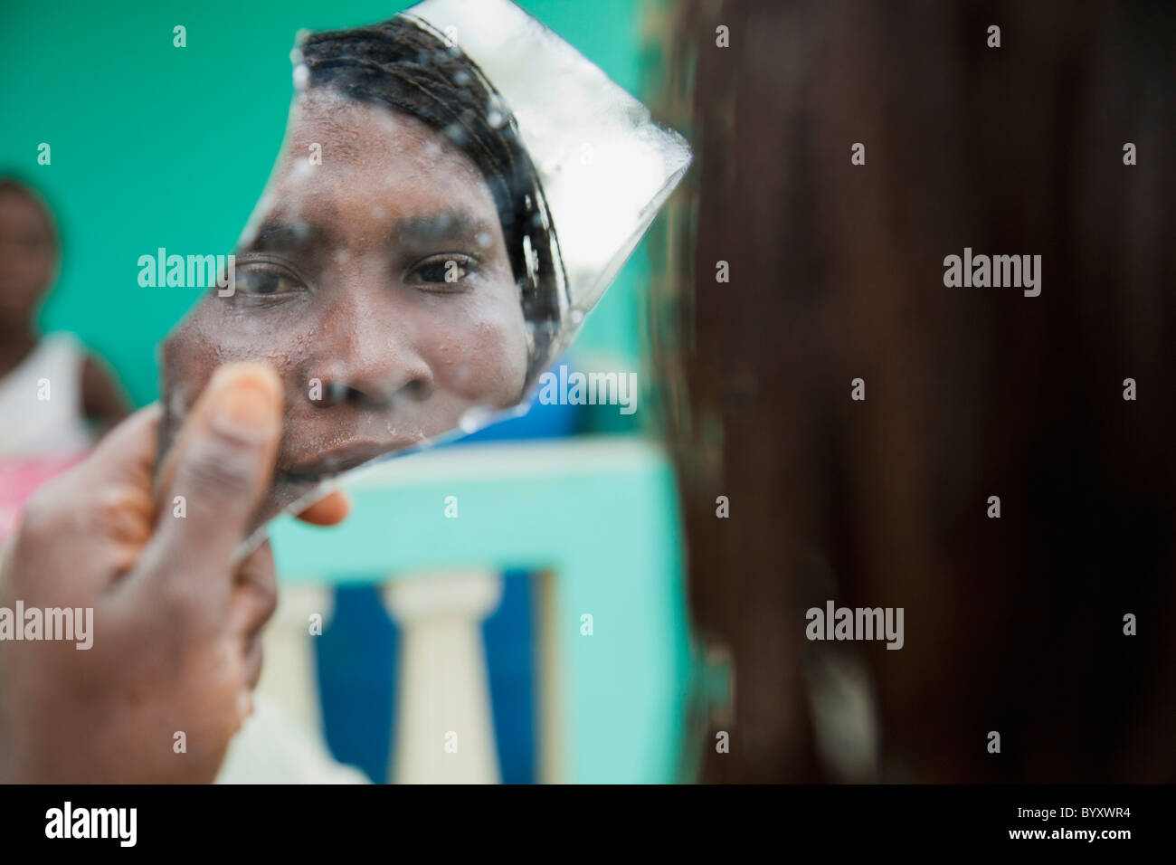 a survivor of an earthquake looks into a broken mirror with a face of ...