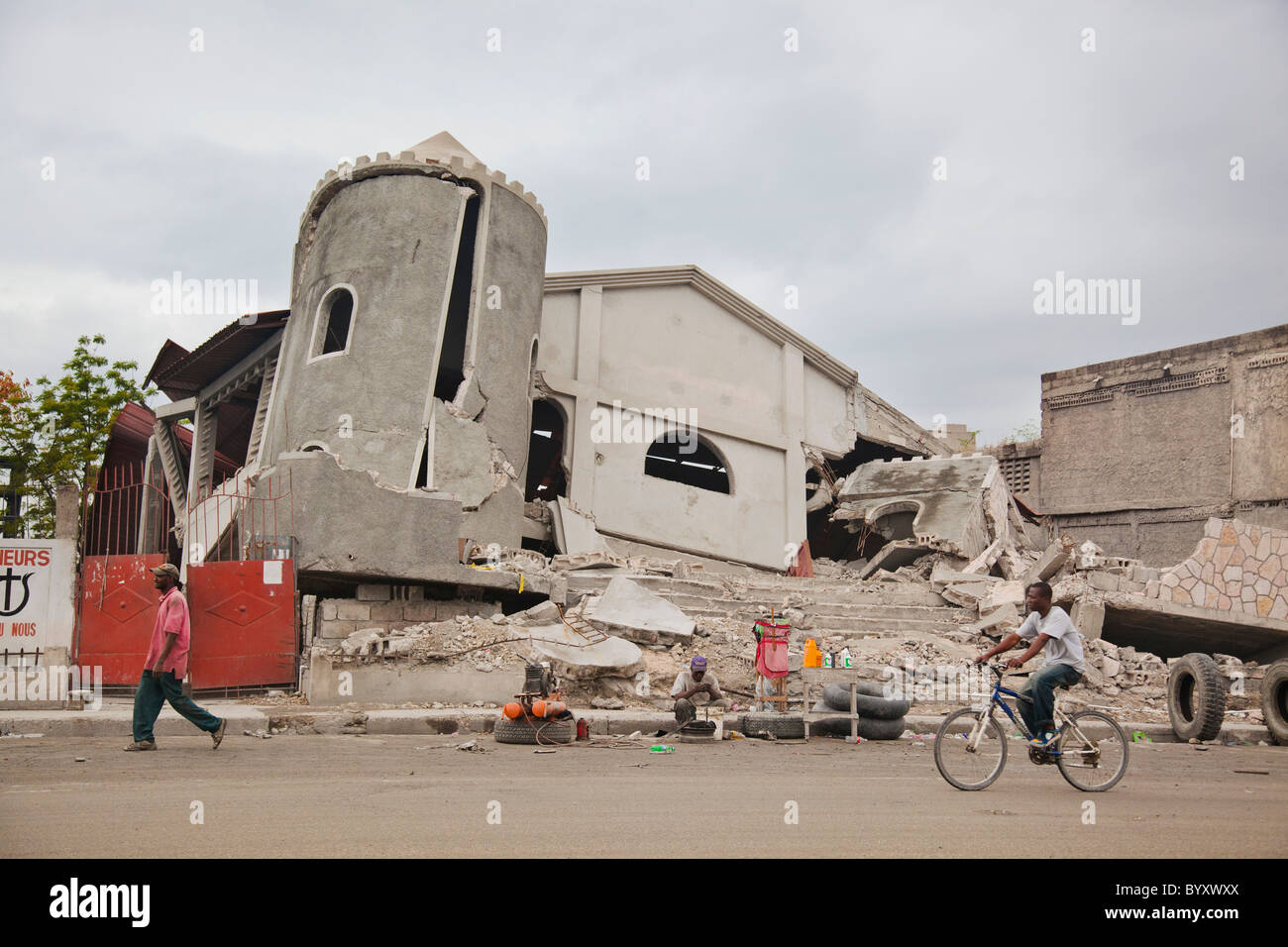 people on the street walking past a collapsed church after the ...