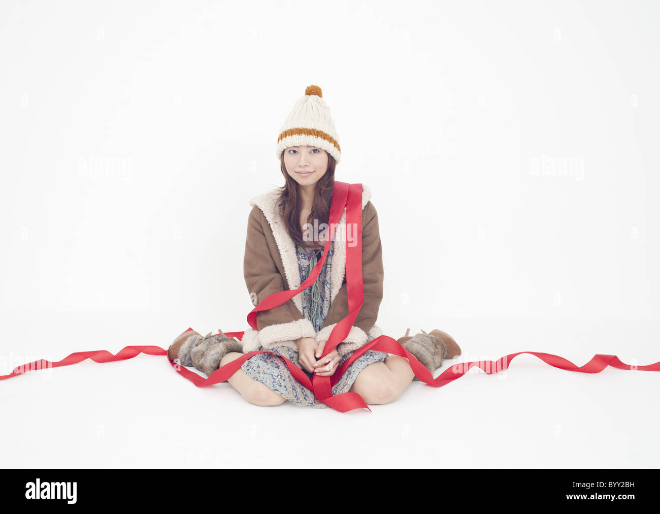 Young woman wrapping ribbons around her body Stock Photo - Alamy