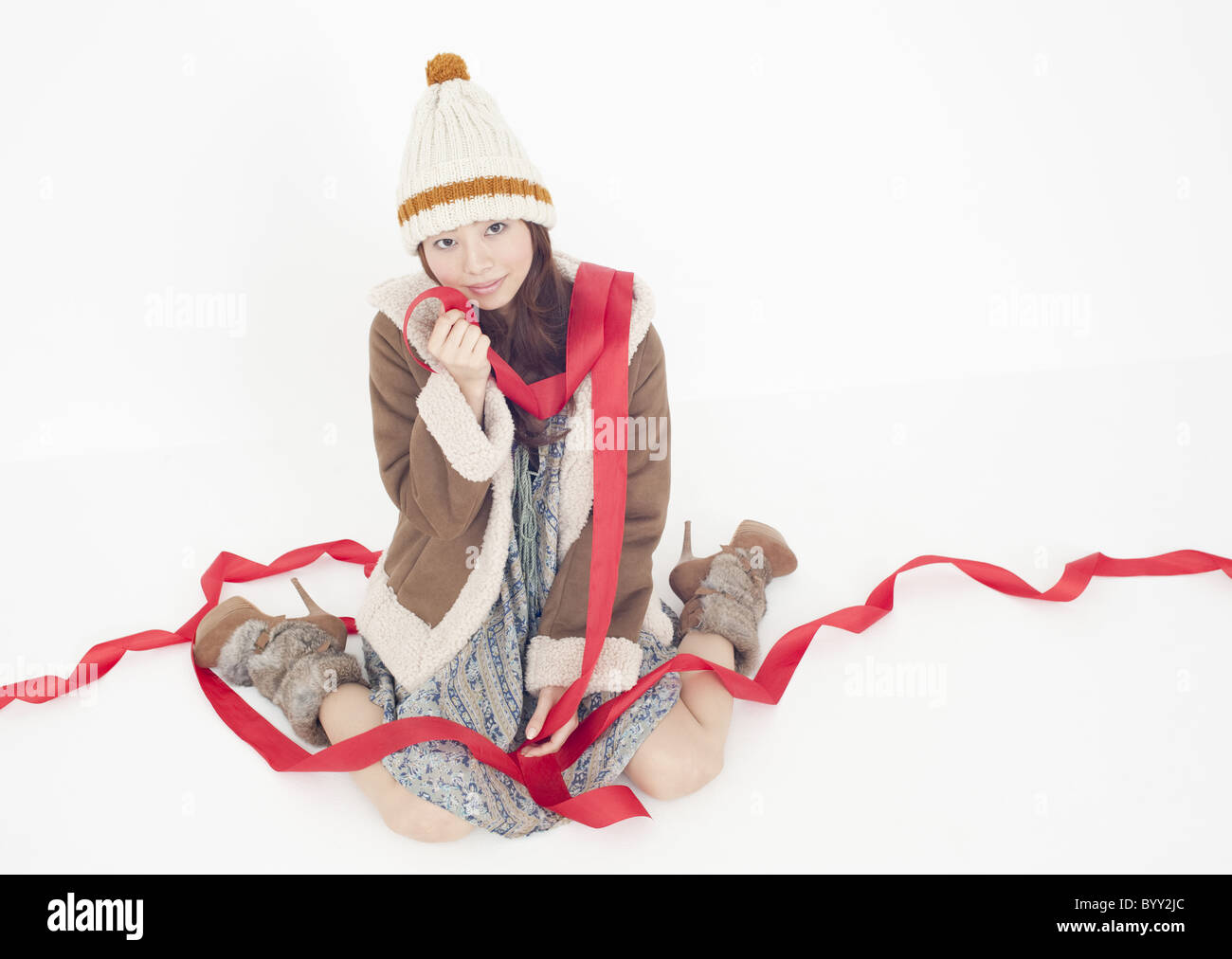 Young woman wrapping ribbons around her body Stock Photo - Alamy