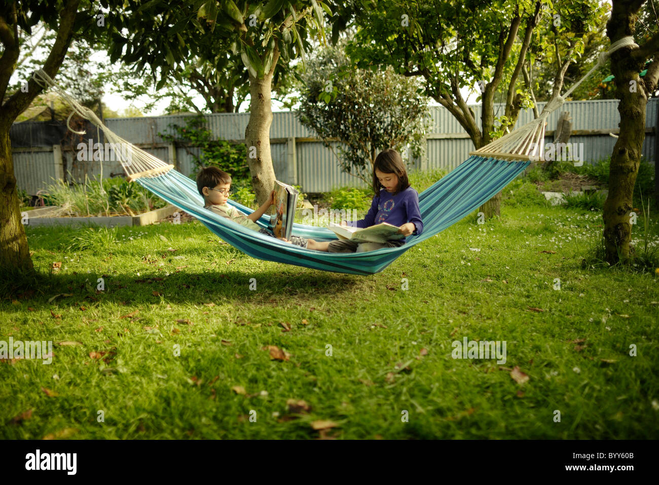 Boy reading book hammock hi-res stock photography and images - Alamy