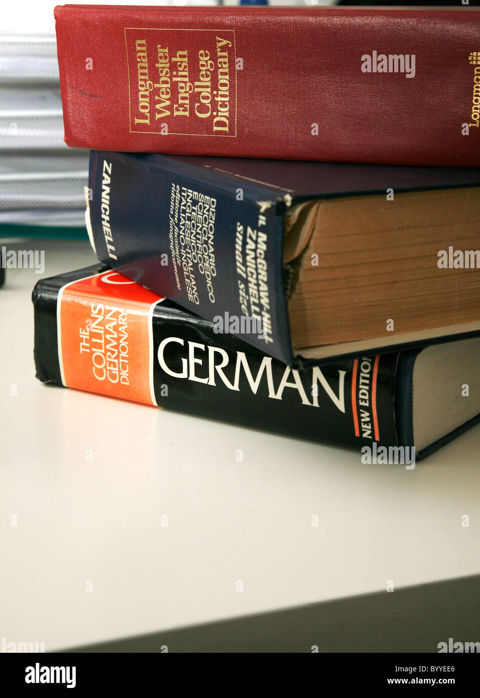 A stack of dictionaries on a desk Stock Photo - Alamy