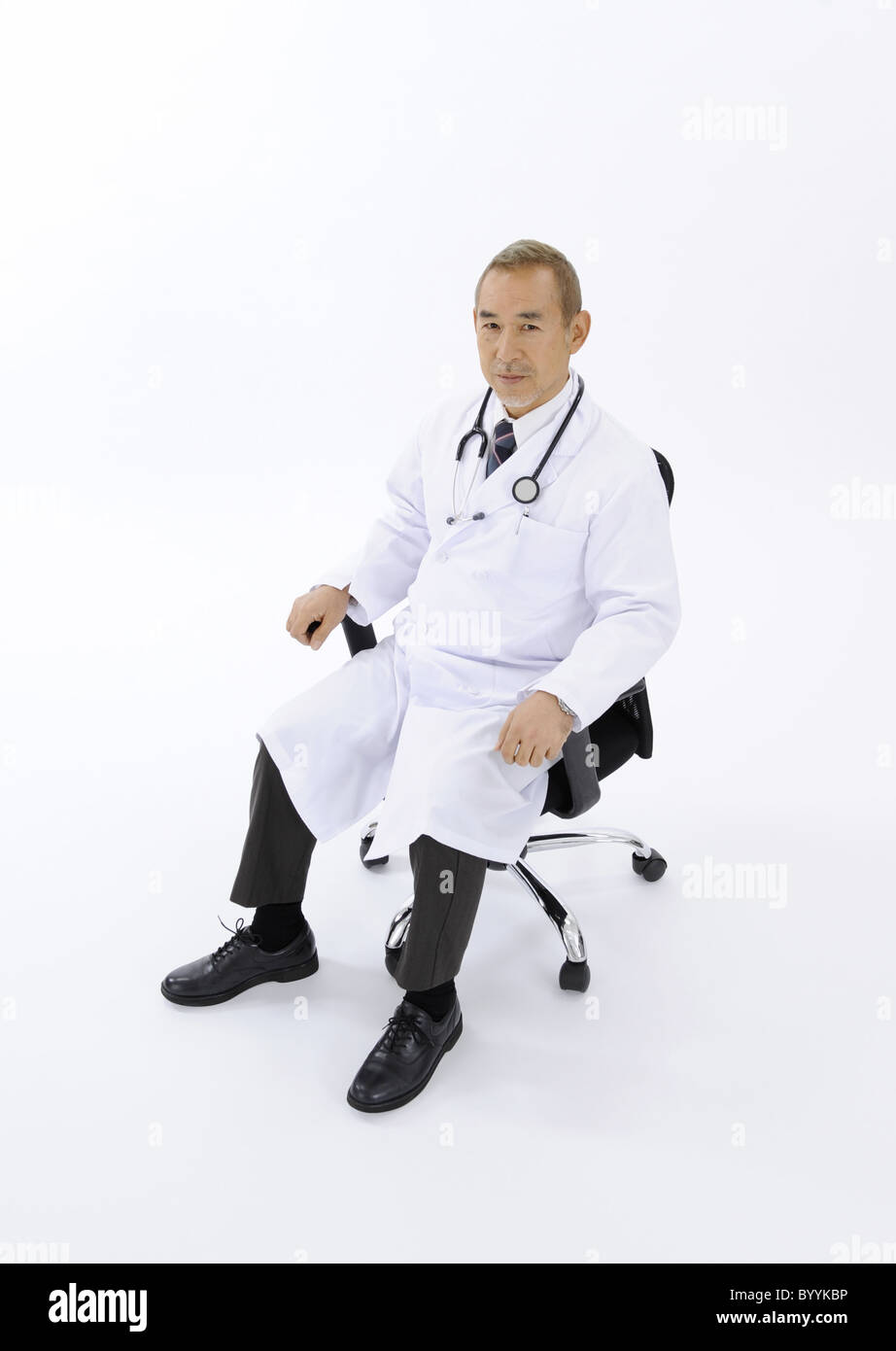 Doctor sitting on chair Stock Photo - Alamy