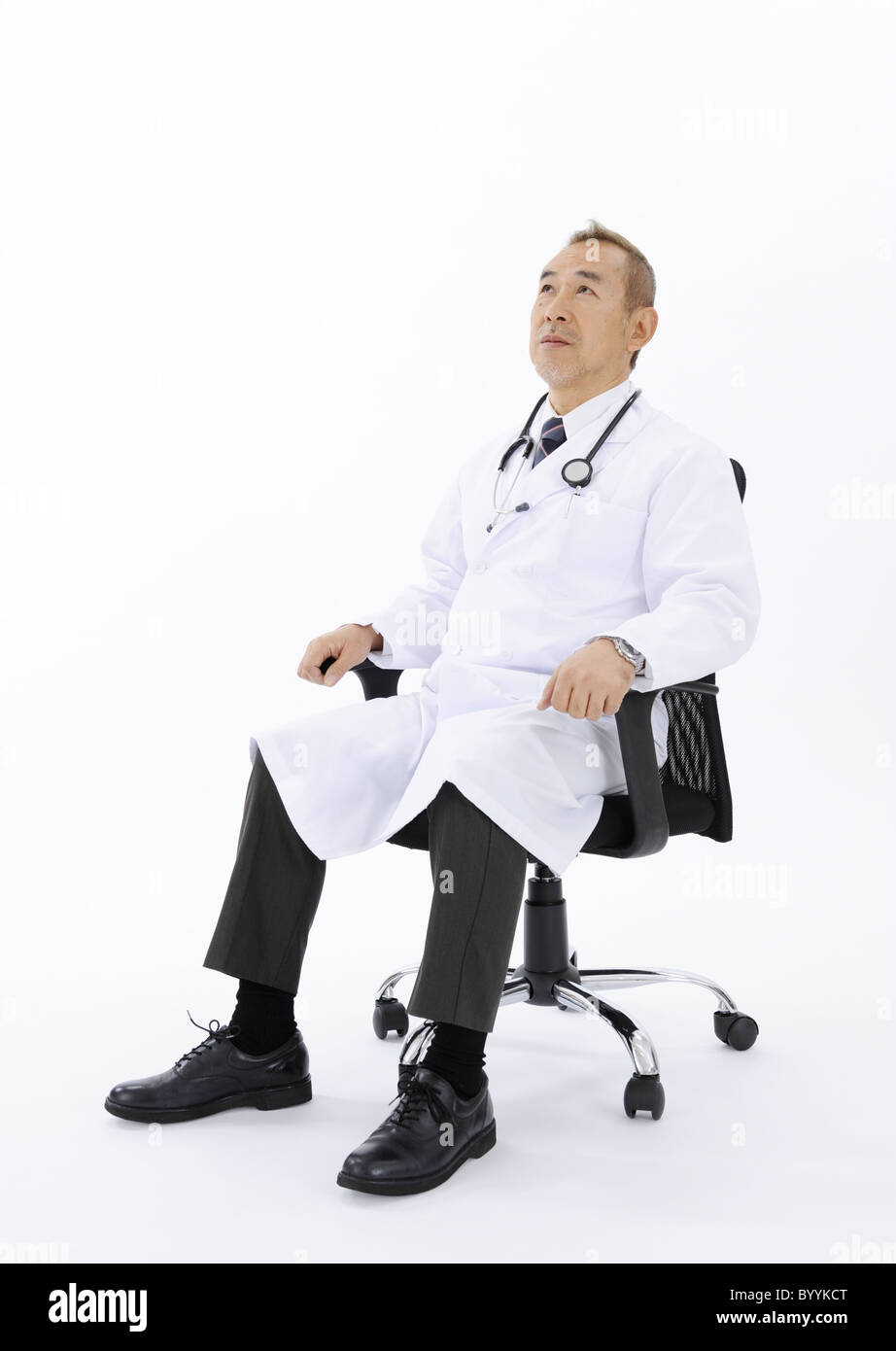 Doctor sitting on chair Stock Photo - Alamy
