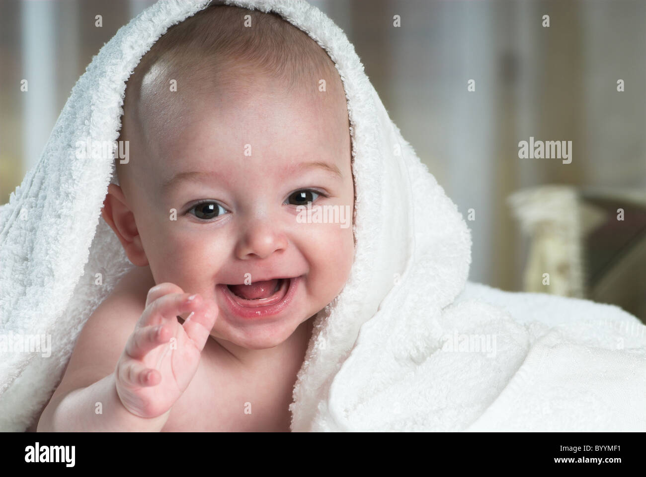 Toothless baby is smiling in bed Stock Photo - Alamy