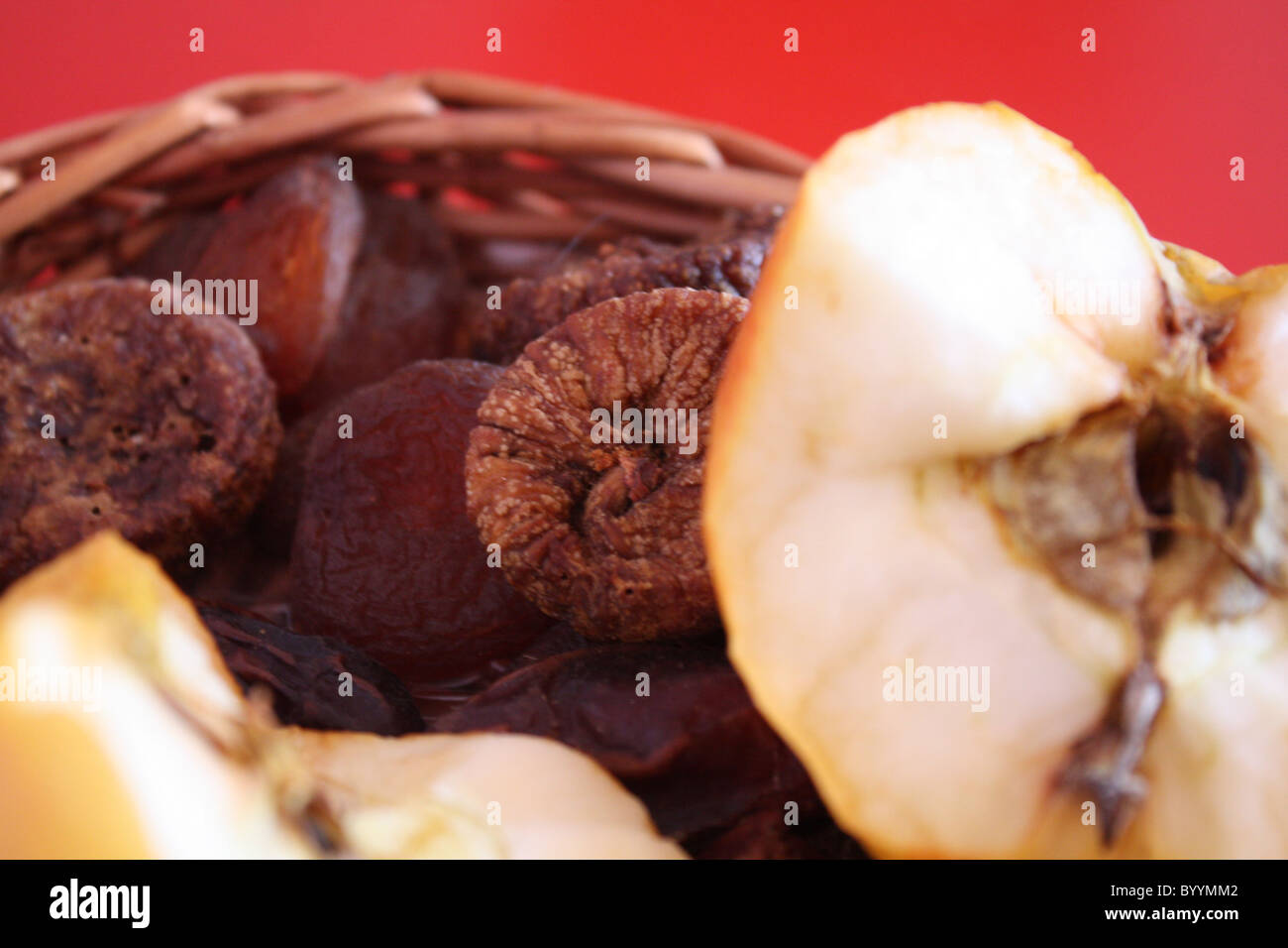 Basket with figs and rotten apple Stock Photo - Alamy