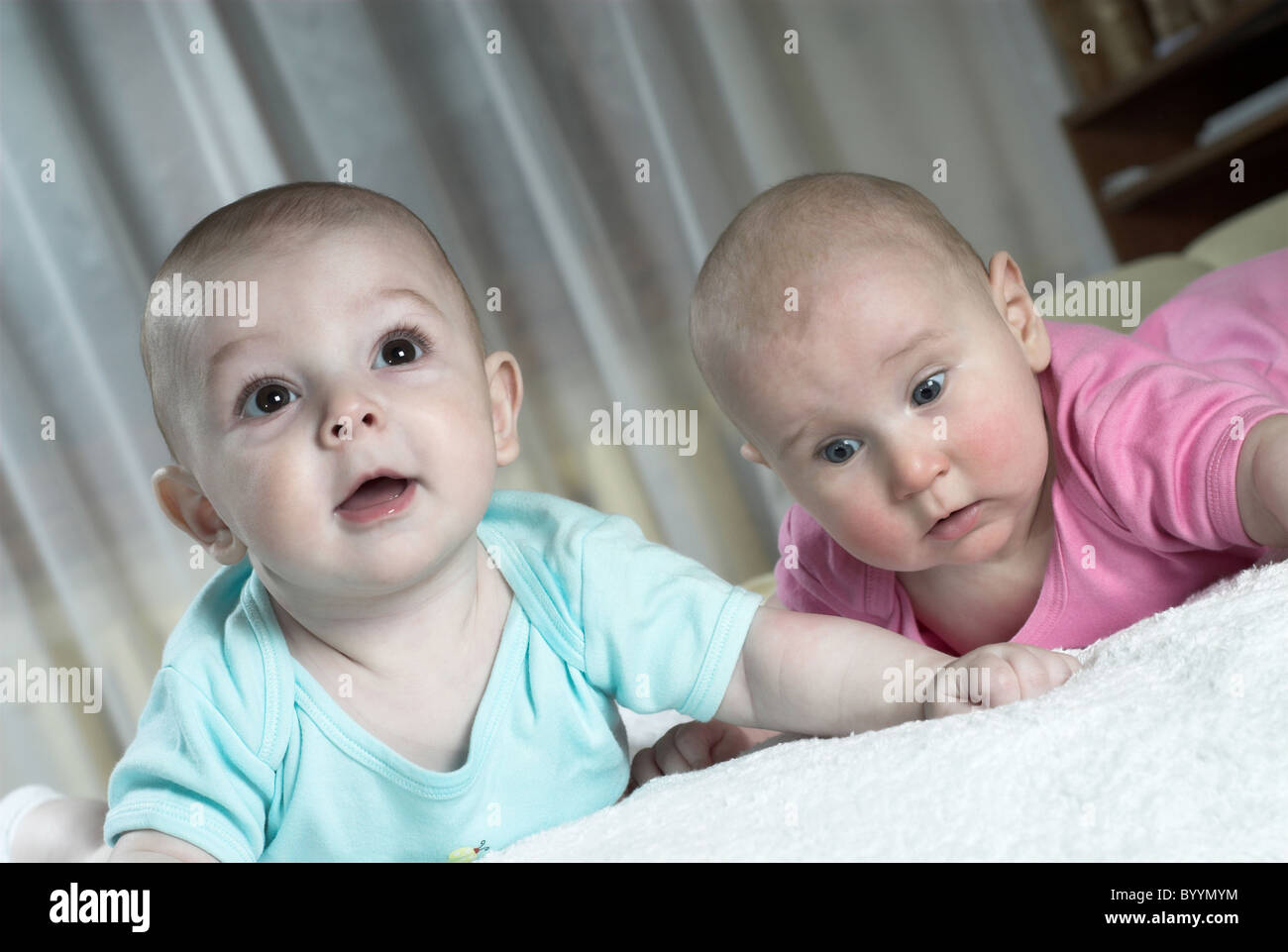 Two little babies are surprised. Toned image Stock Photo - Alamy