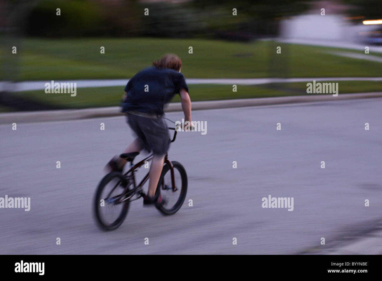 Young boy riding bicycle Stock Photo - Alamy