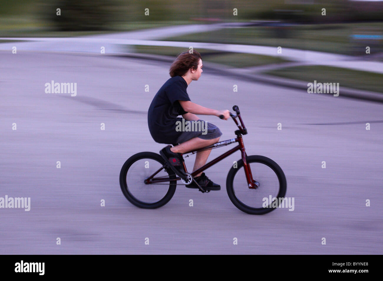 Young boy riding bicycle Stock Photo - Alamy
