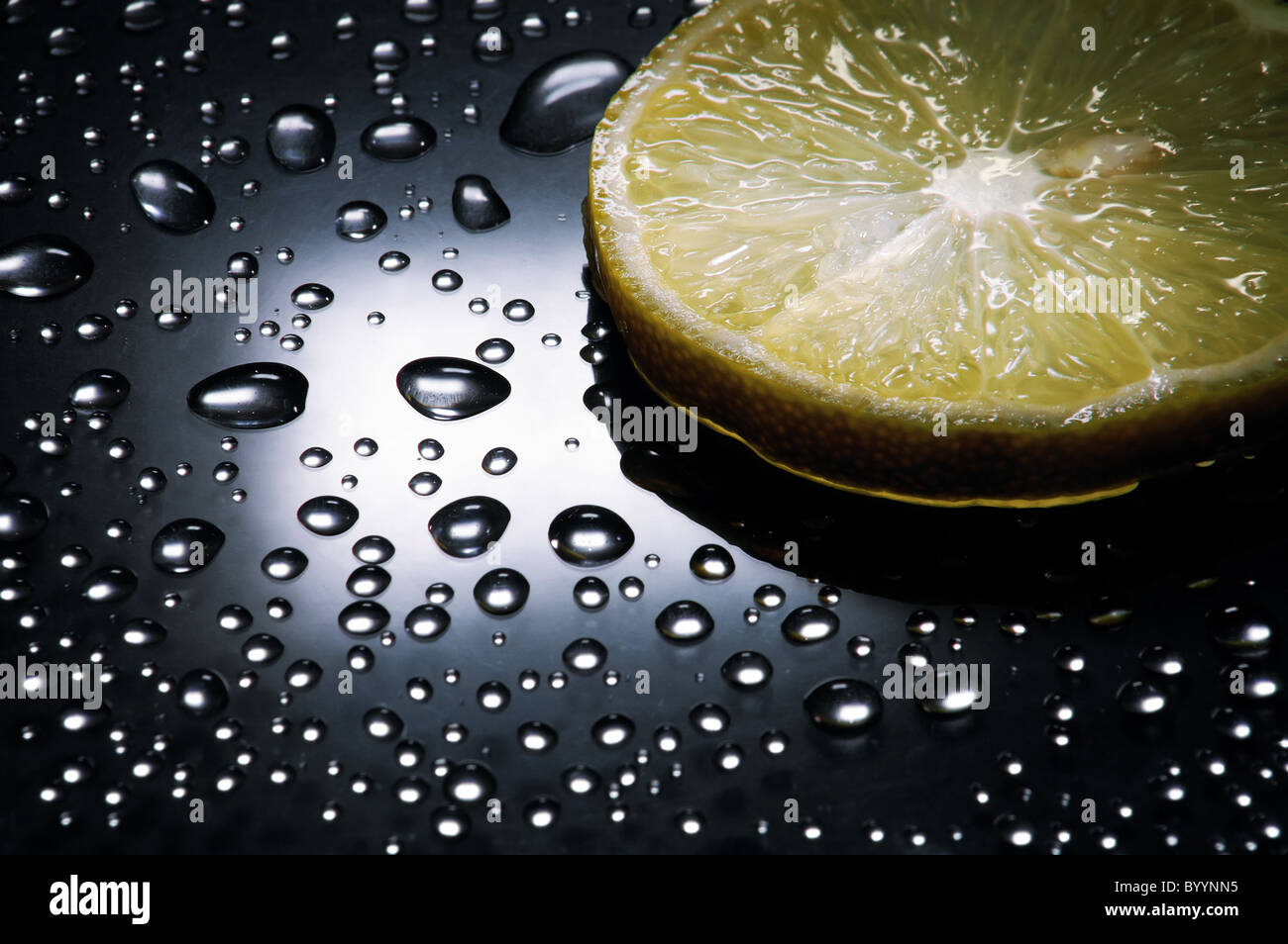 Lemon slice , water droplets, dramatic lighting,vertical Stock Photo - Alamy