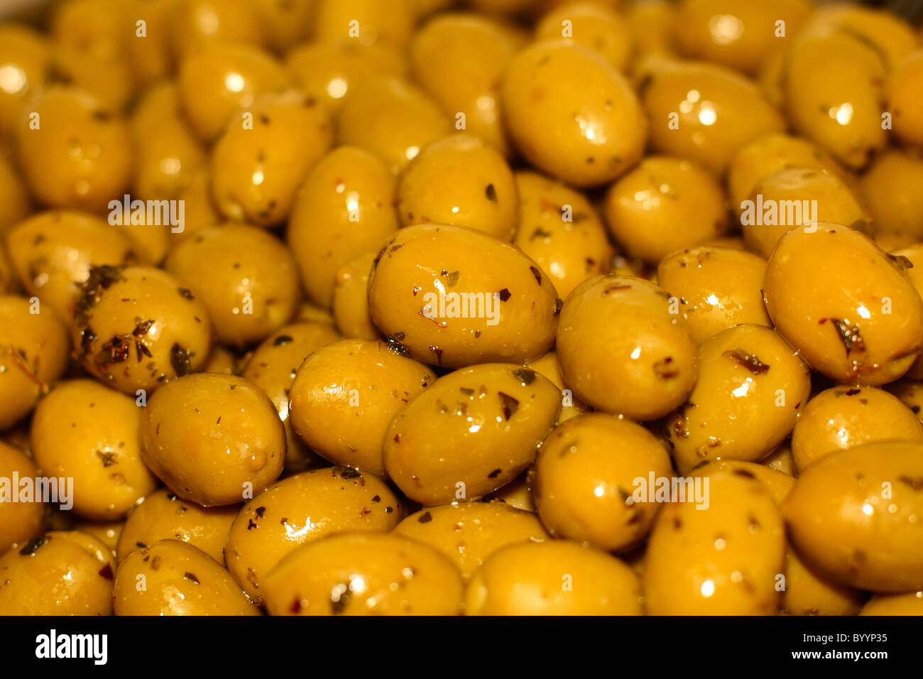 background of the large green olives in oil Stock Photo - Alamy