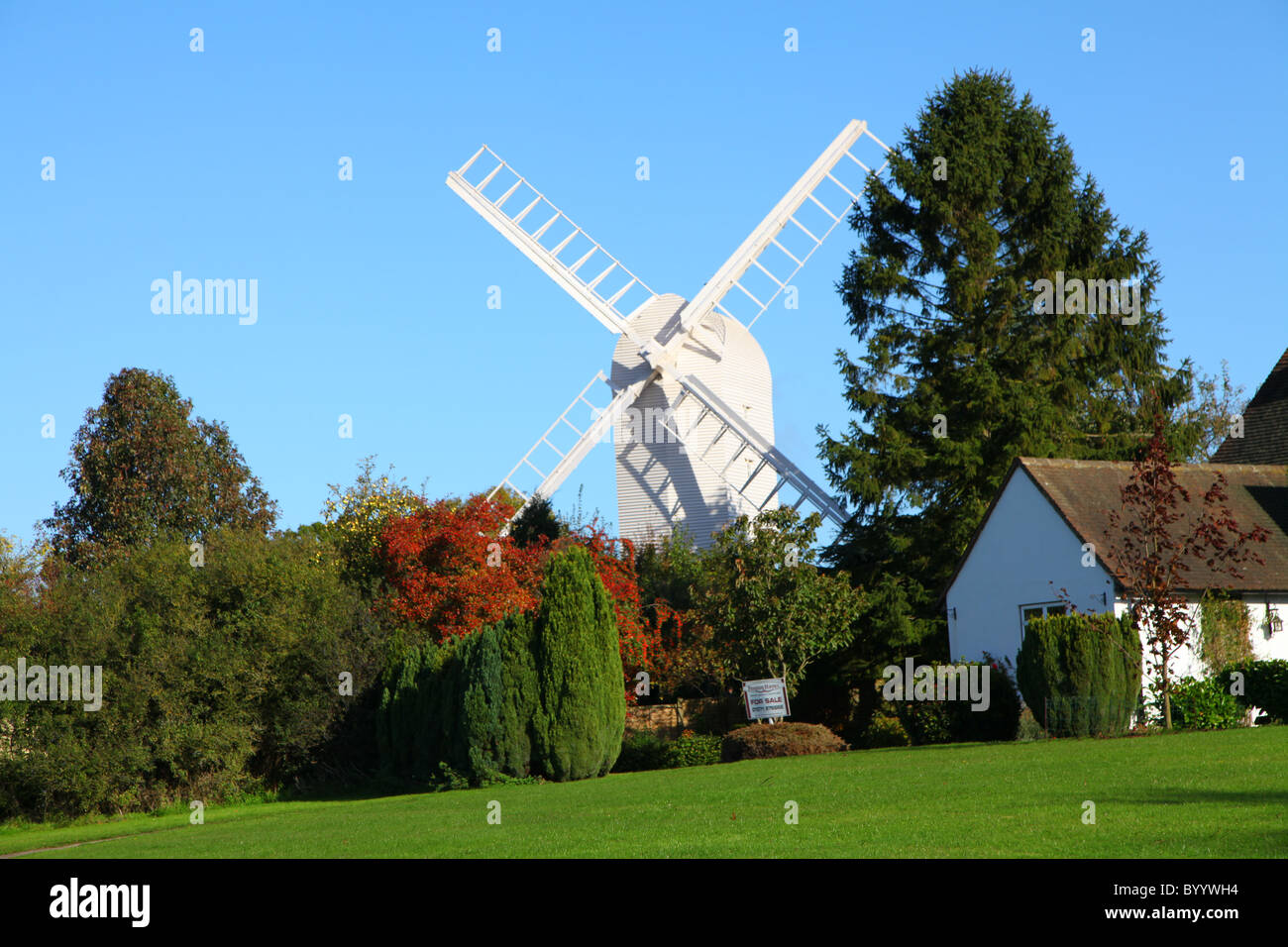 Windmill in pretty English village Stock Photo - Alamy