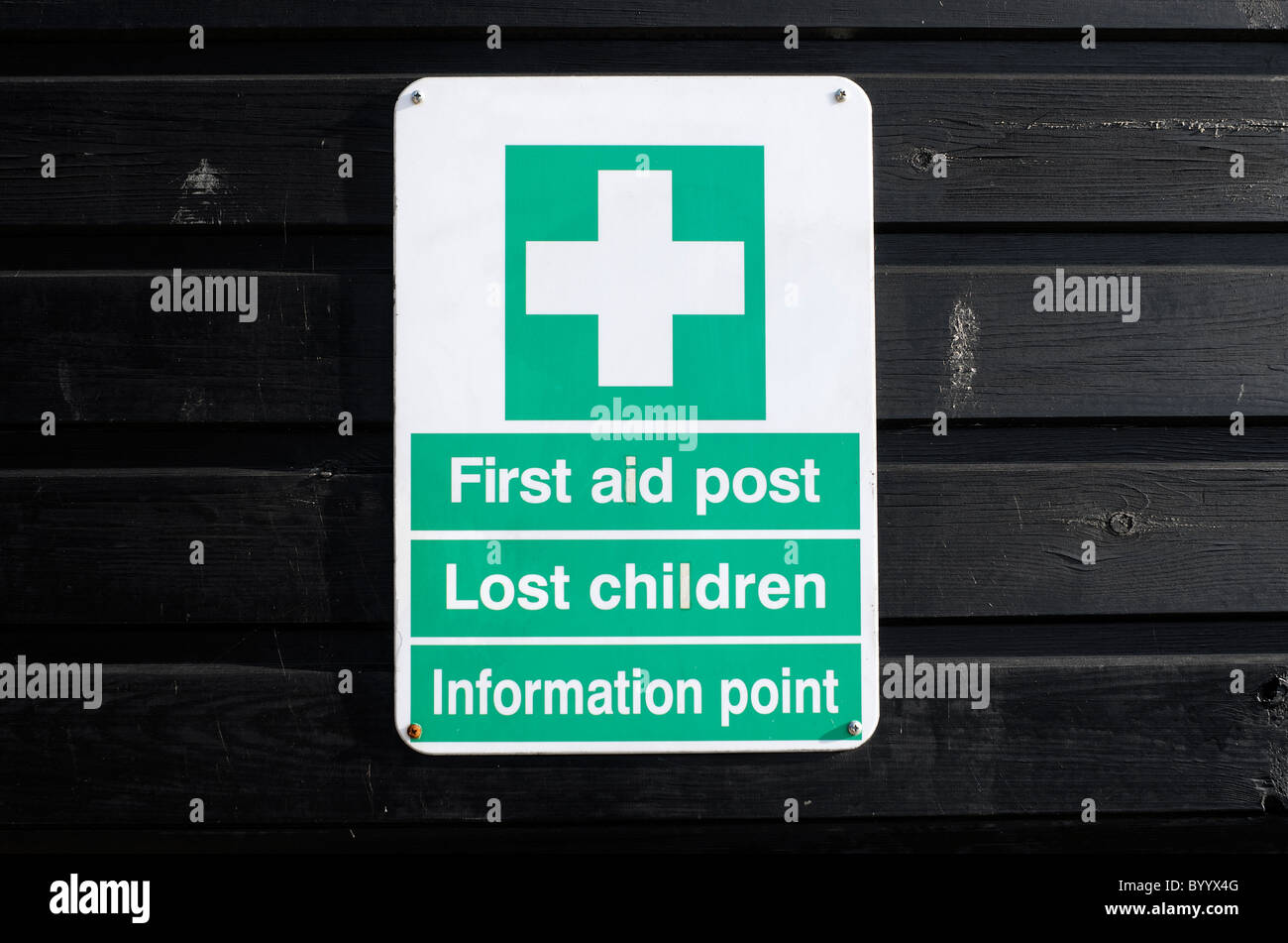 First aid post lost children Information point sign on black shed Stock ...