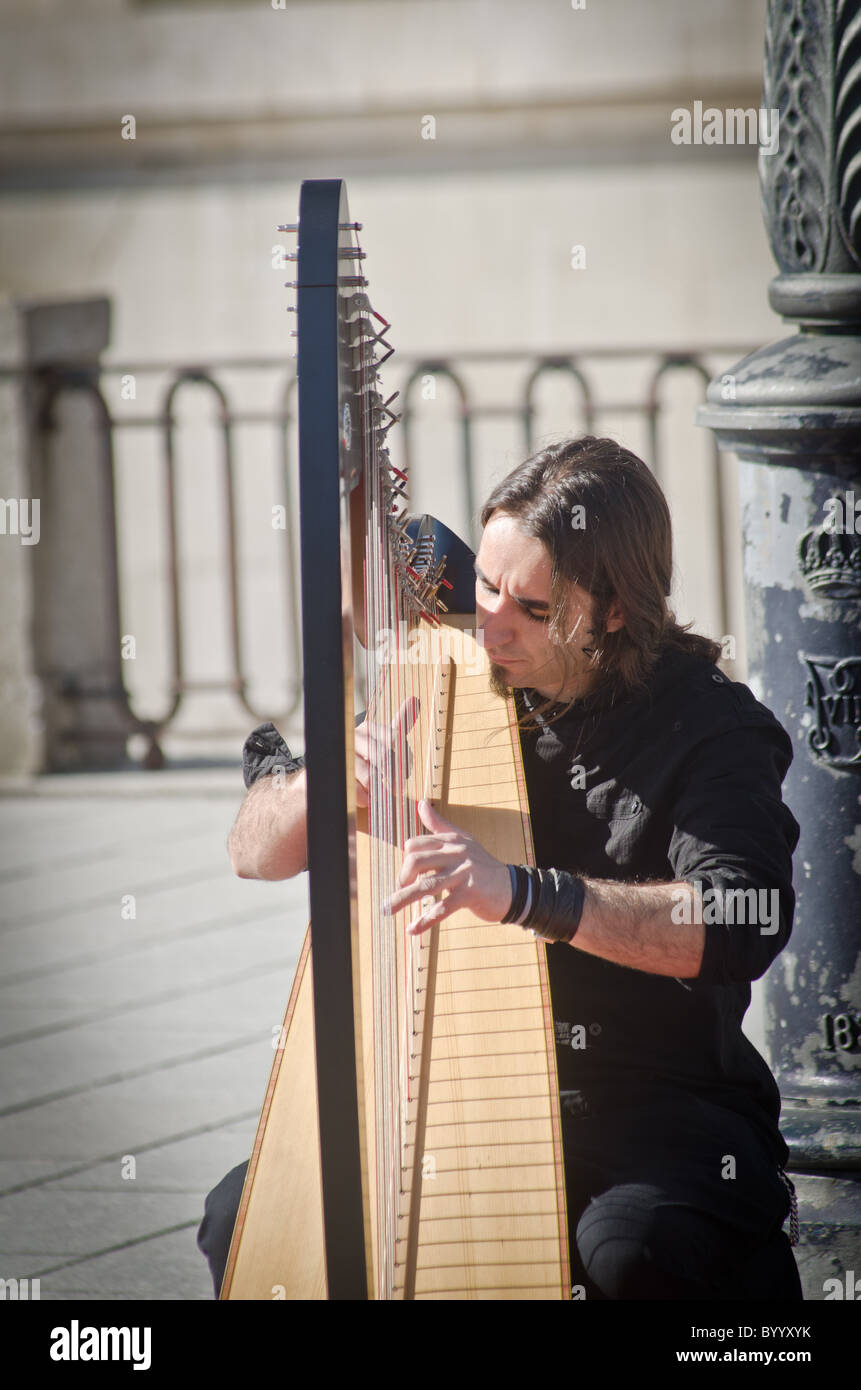 Man playing harp Stock Photo - Alamy