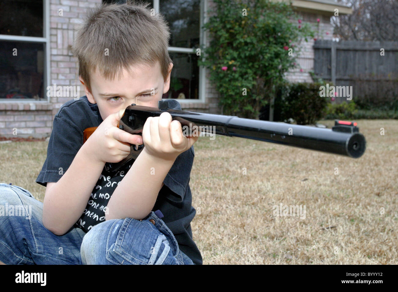 Young boy playing and aiming with an Air rifle Stock Photo - Alamy